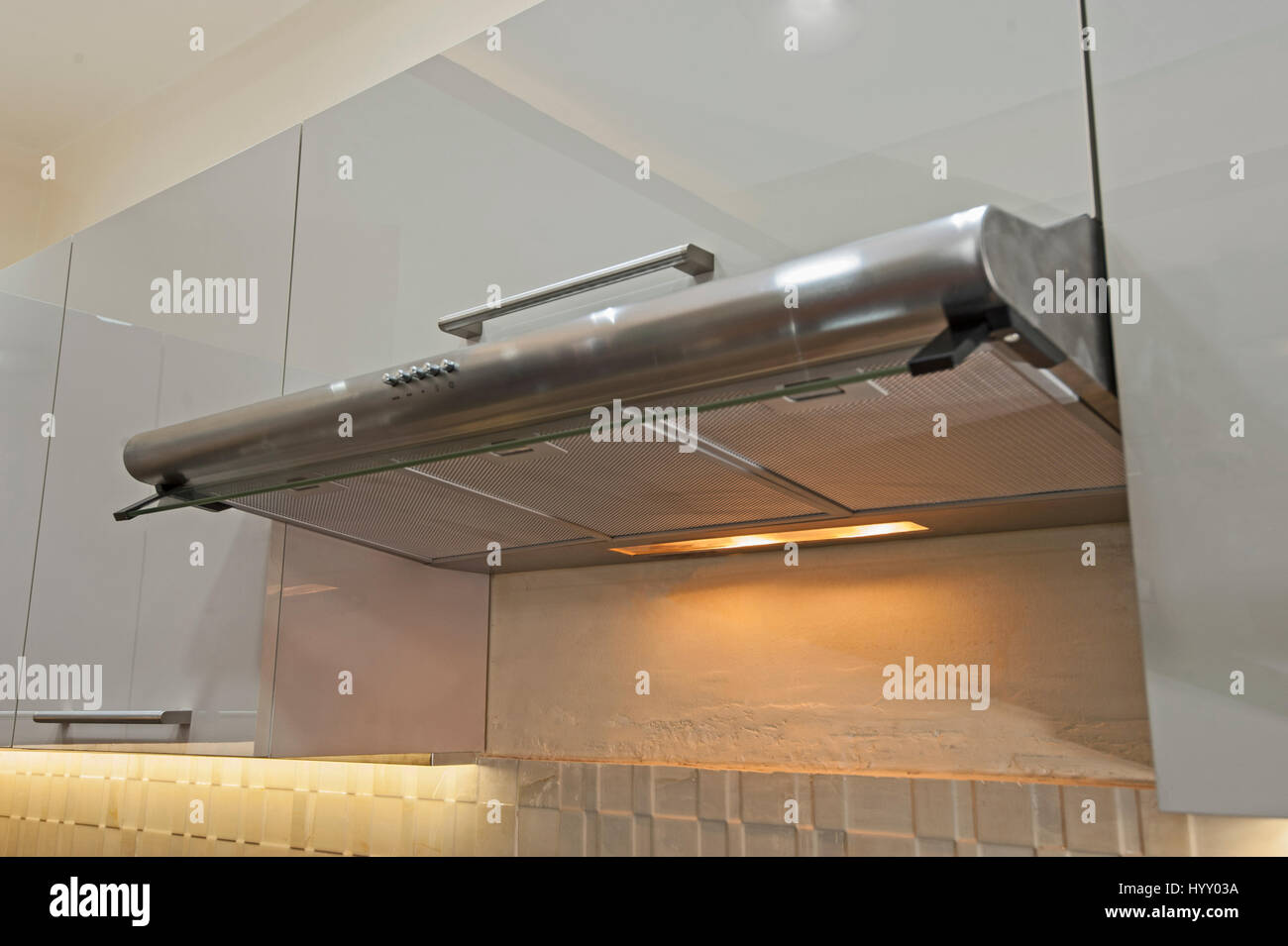 Closeup detail of buttons on metal cooker hood extractor fan with ...