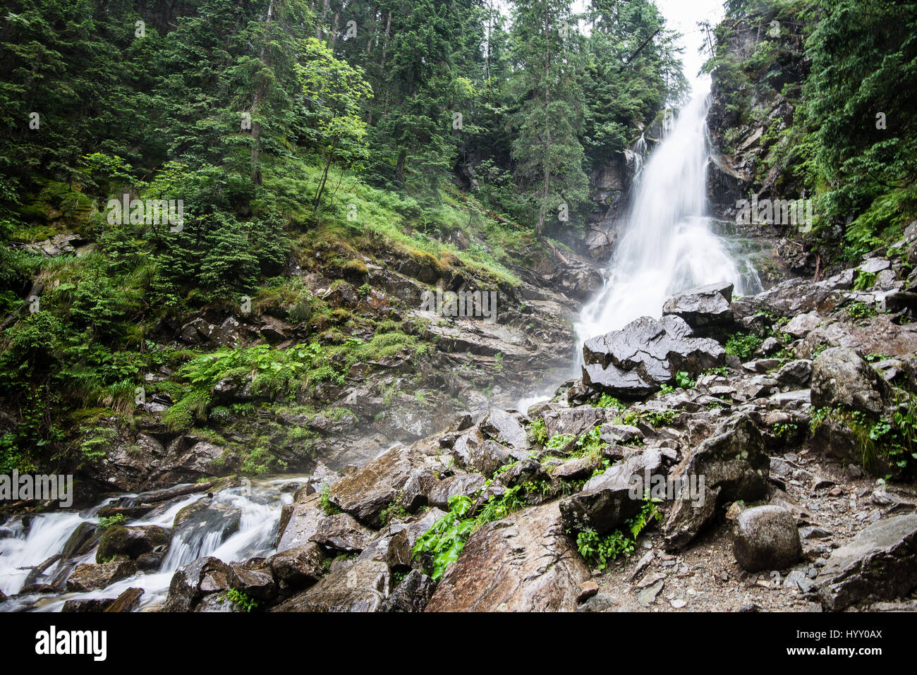 Waterfall from ravine in mountain river in rocks Stock Photo - Alamy