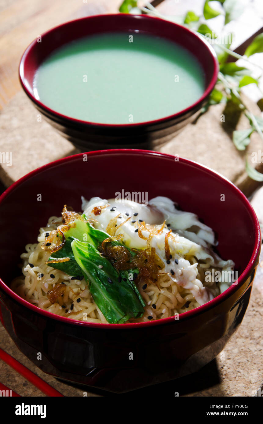 indomie noodles green tea sauce with eggs, as a background ice tea and ...