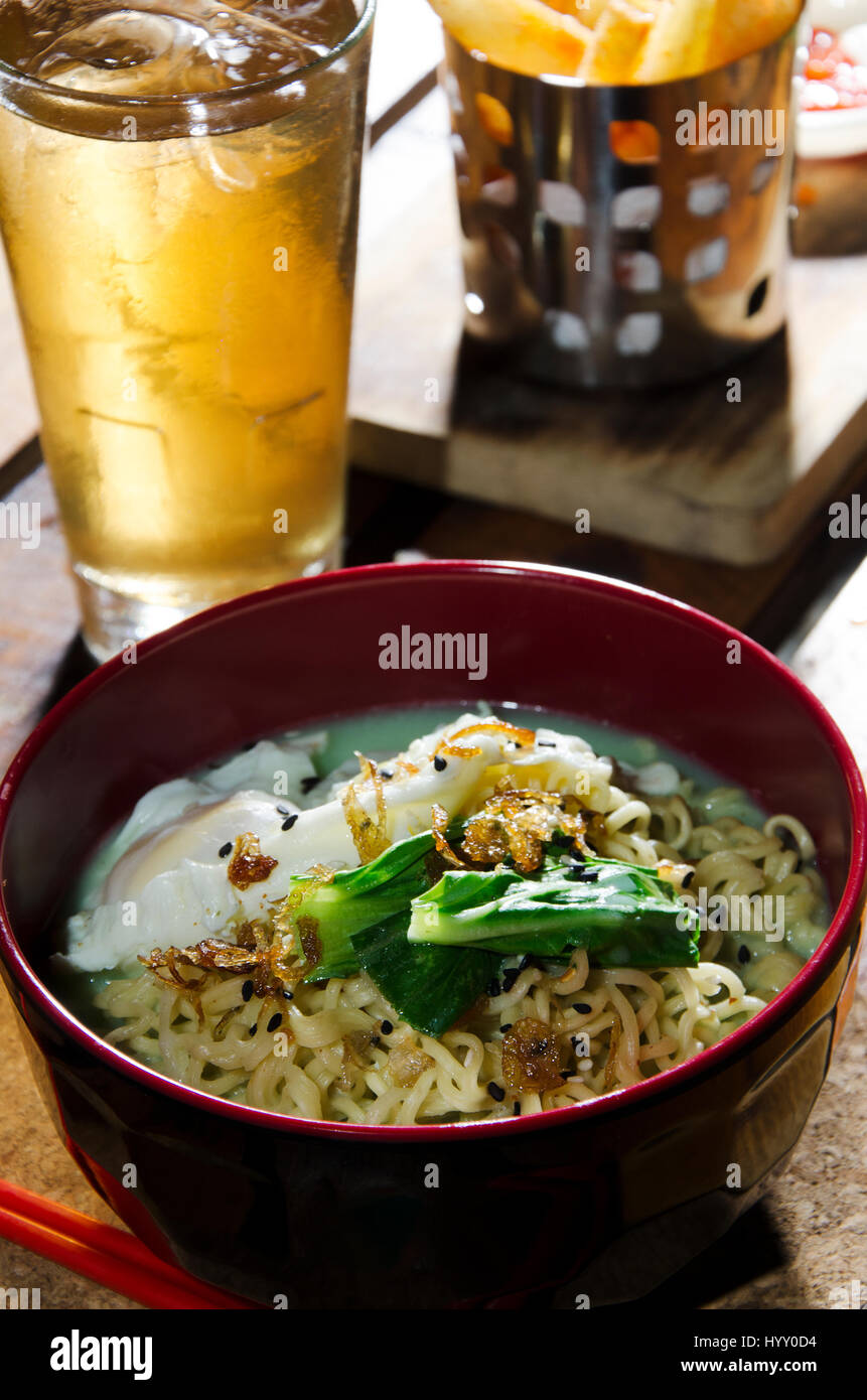 indomie noodles green tea sauce with eggs, as a background ice tea and ...