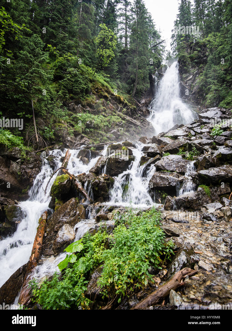 Waterfall from ravine in mountain river in rocks Stock Photo - Alamy