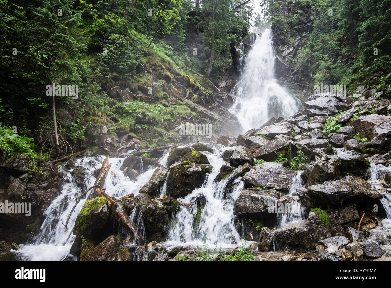 Waterfall from ravine in mountain river in rocks Stock Photo - Alamy