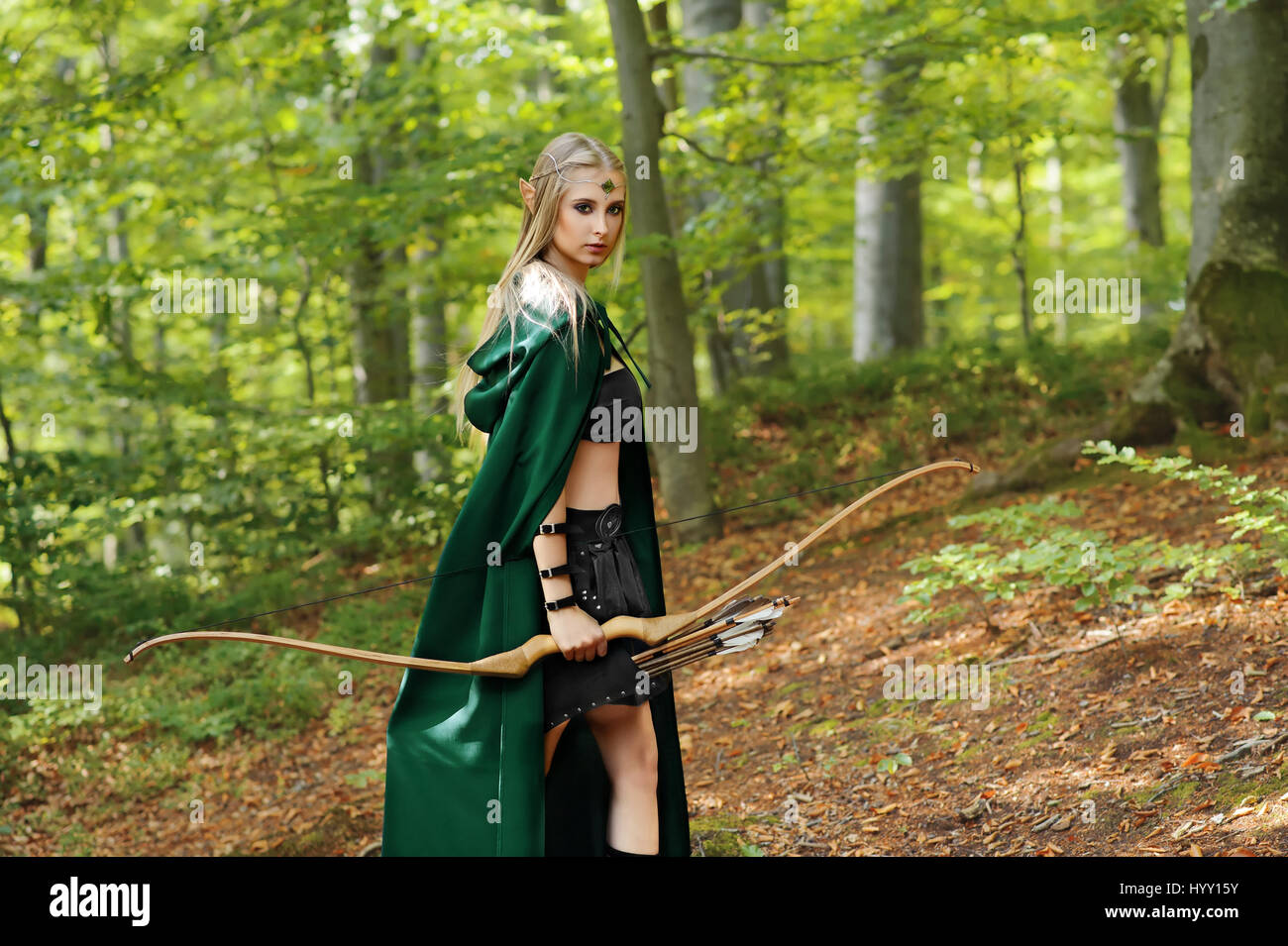 Beautiful young female elf looking to the camera over her shoulder ...
