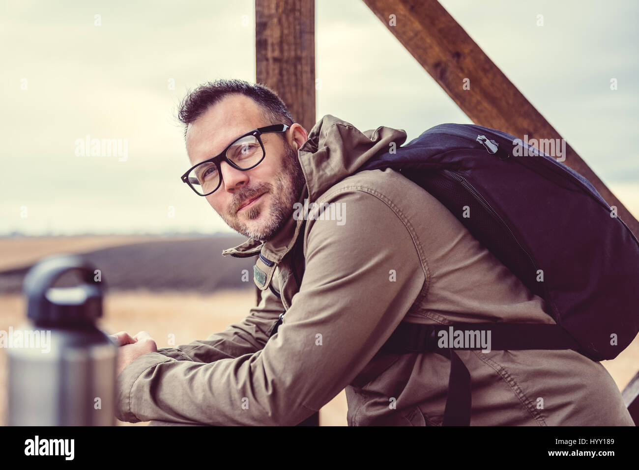 Hiker wearing backpack resting in hikers rest cabin Stock Photo - Alamy