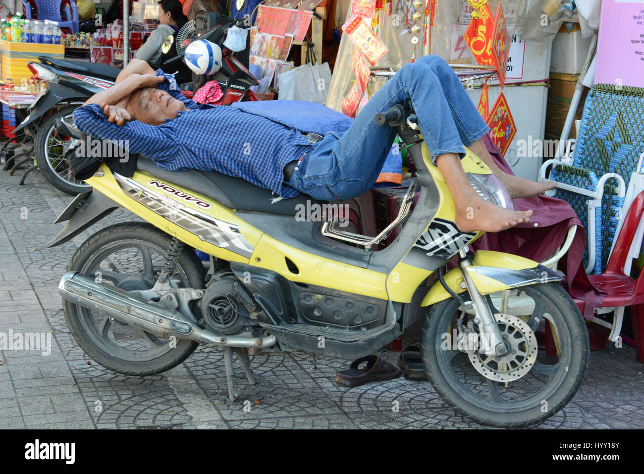 Man sleeping on motor bike hi-res stock photography and images - Alamy