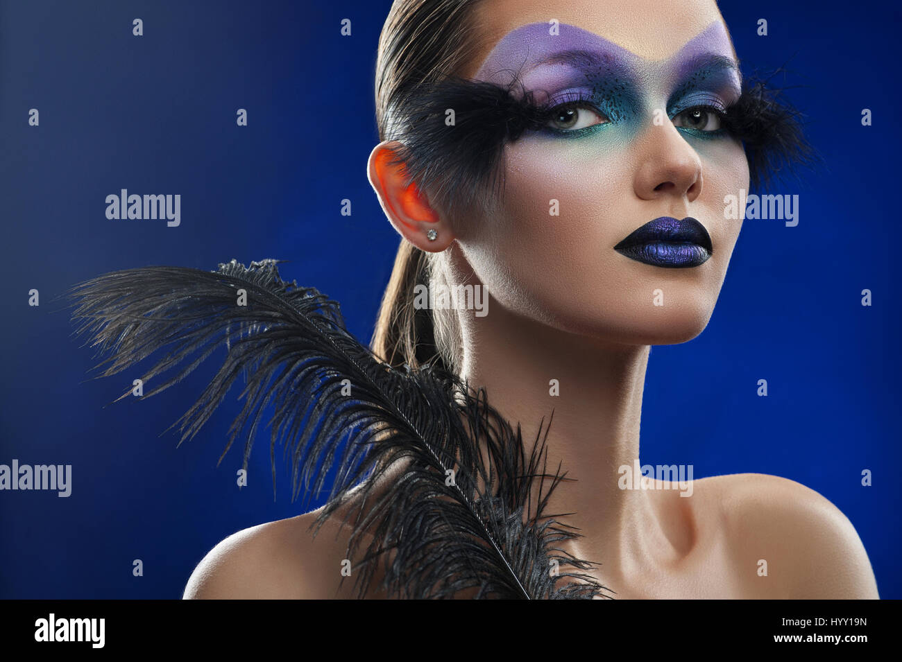 Queen of blue. Studio portrait of an attractive young woman wearing ...