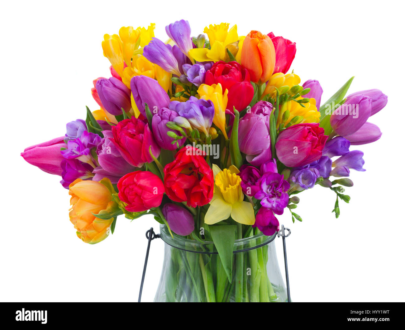 bouquet of bright spring flowers in glass vase close up isolated on ...