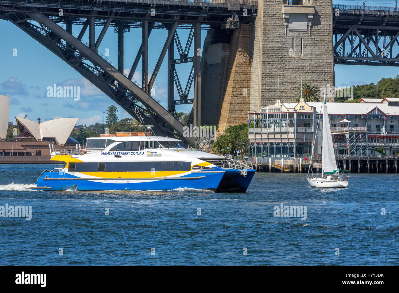 Manly fast ferry travelling on Sydney harbour with Opera House and ...