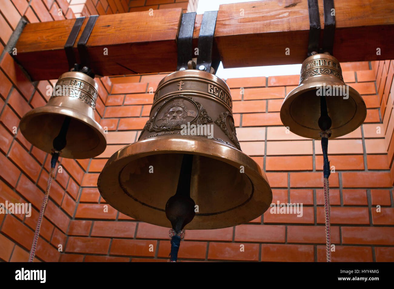 Religious Christian bells. Brick bell tower. The ringing of the bell ...