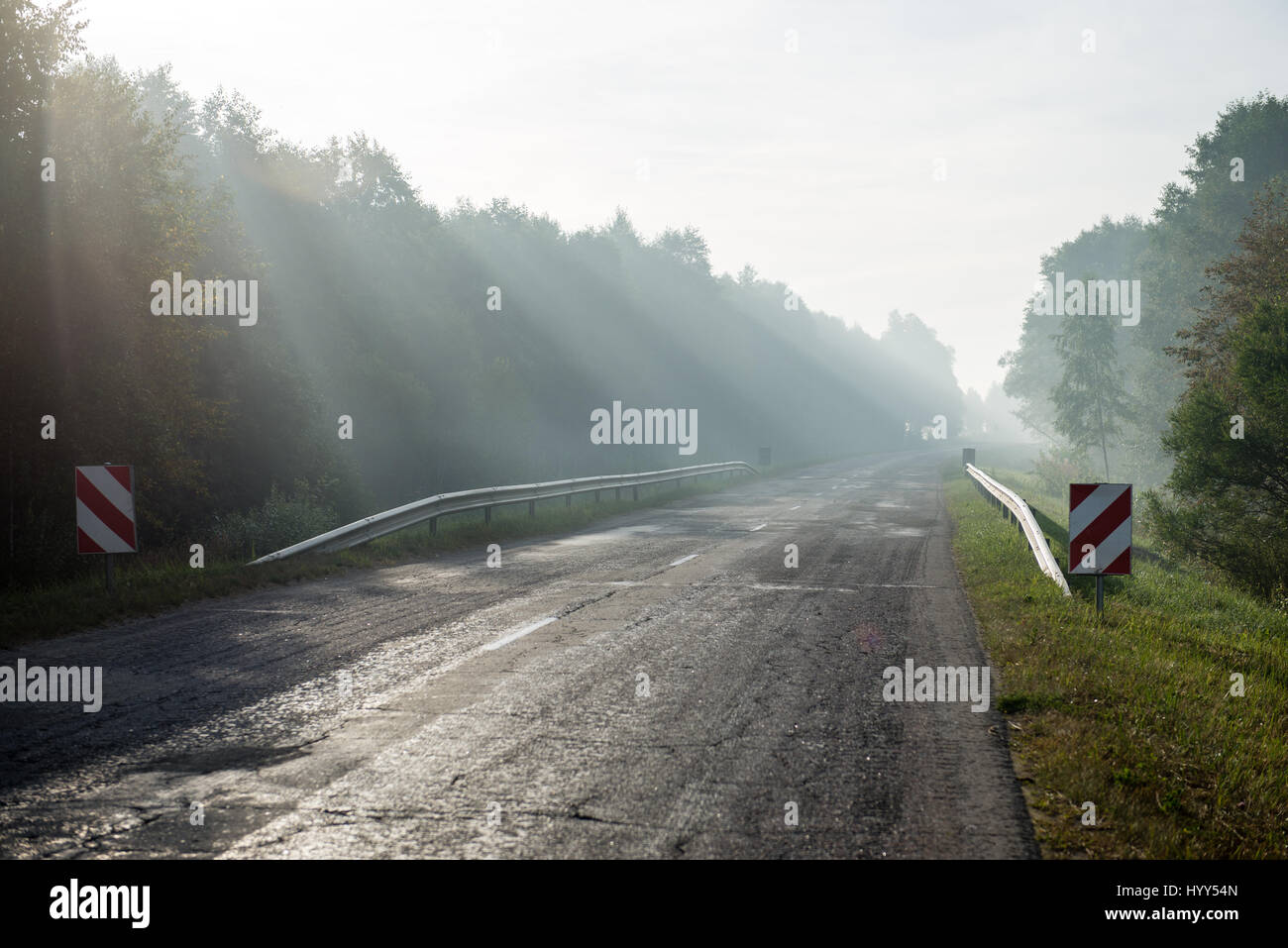 Light rays in fog over the road in country Stock Photo - Alamy