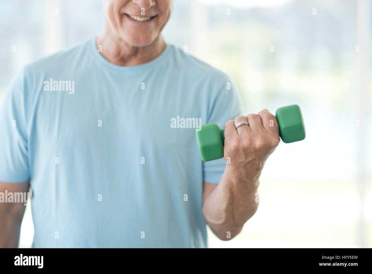 Senior man using hand weights Stock Photo - Alamy