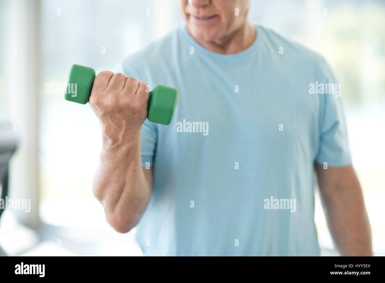 Senior man lifting weights hi-res stock photography and images - Alamy