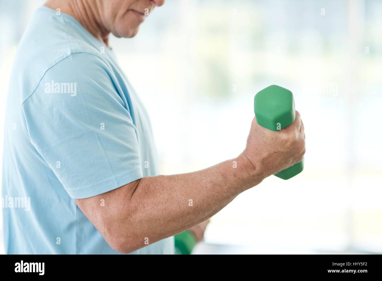 Senior man using hand weights Stock Photo - Alamy