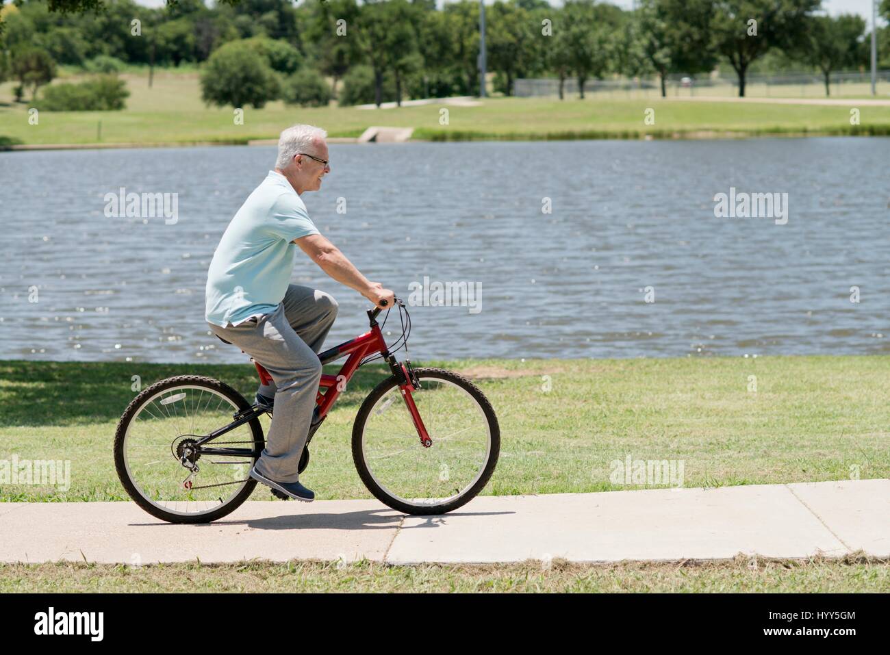 Senior man riding a bicycle Stock Photo - Alamy