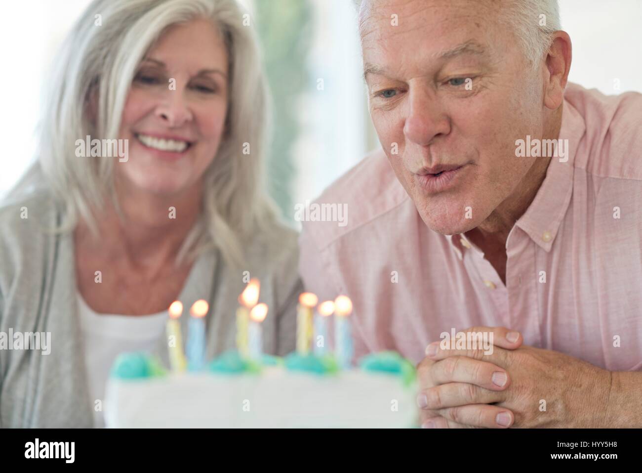 Senior couple with birthday cake Stock Photo - Alamy
