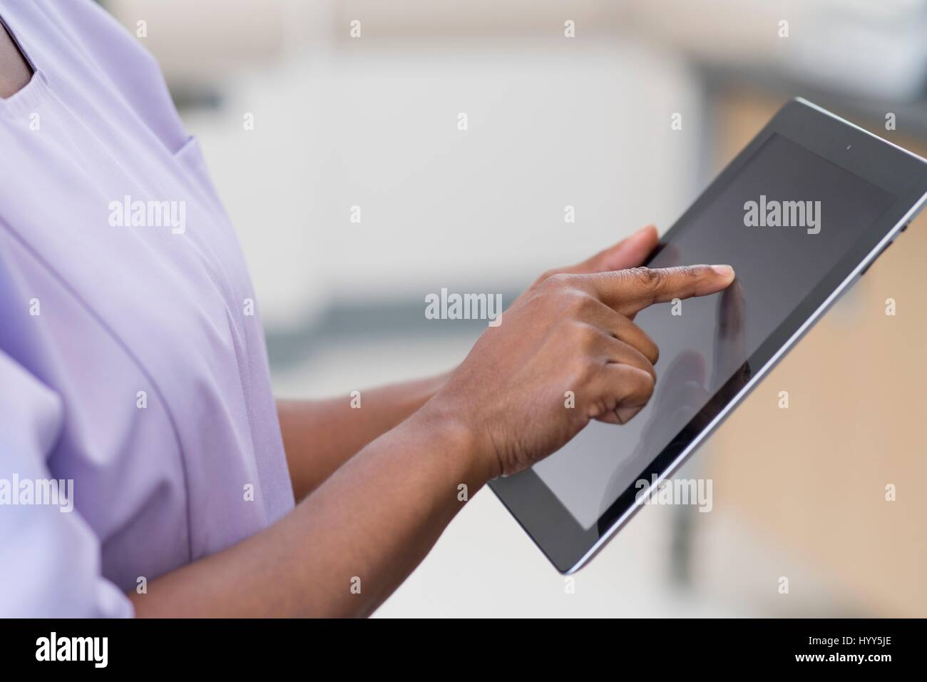 Female nurse using digital tablet Stock Photo - Alamy