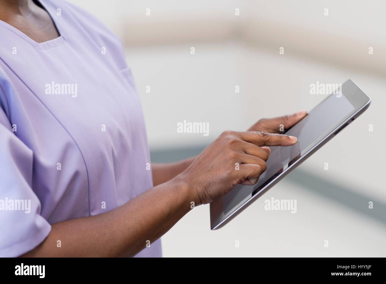 Female nurse using digital tablet Stock Photo - Alamy