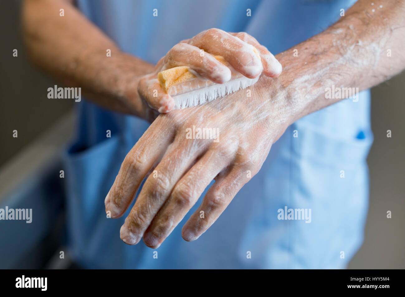 Doctor scrubbing hands with brush in hospital Stock Photo - Alamy