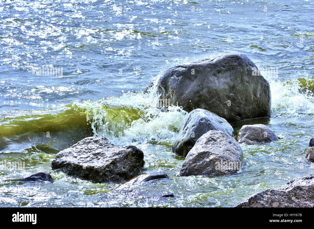 Ocean water rushing by a rock Stock Photo - Alamy