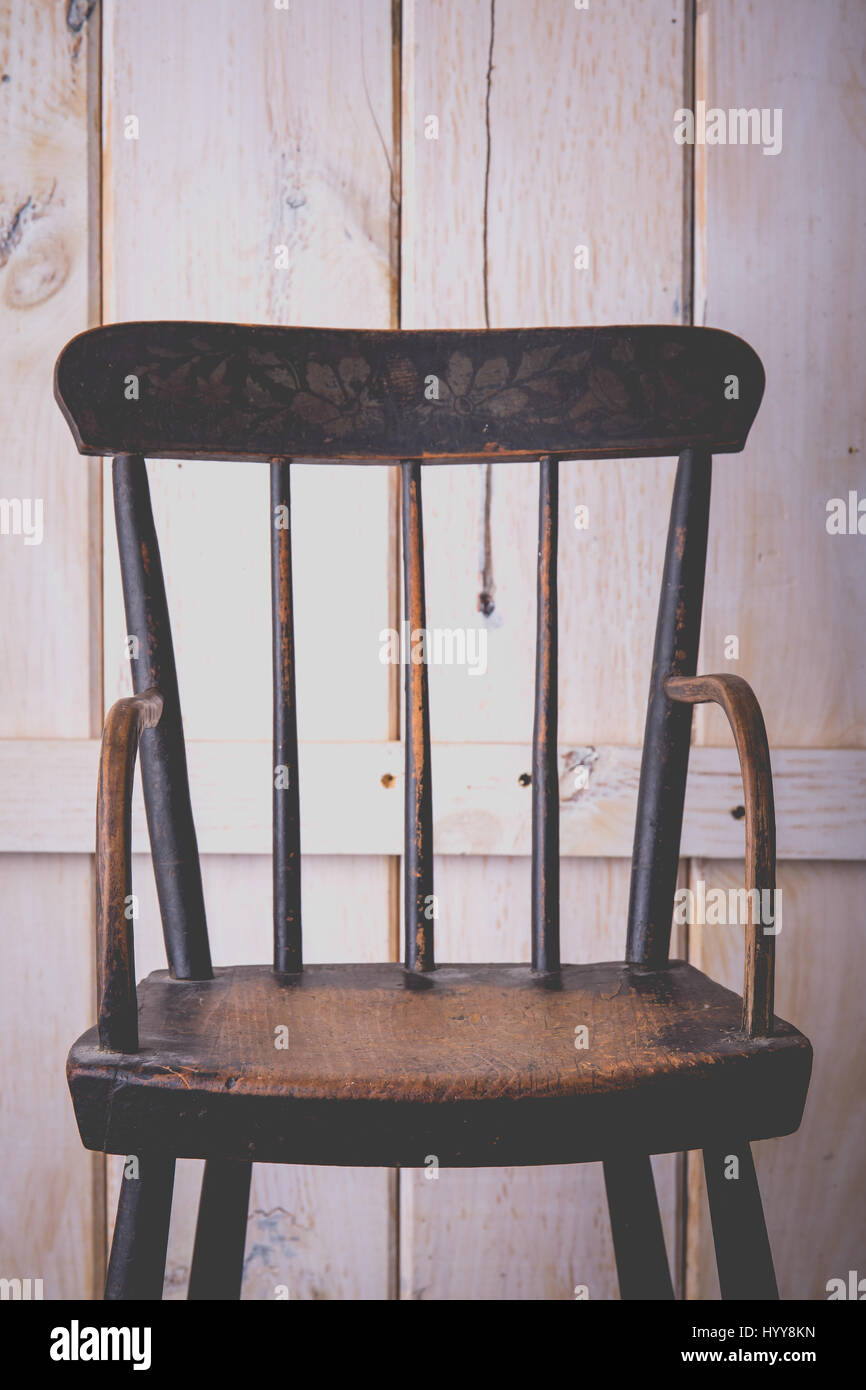 An old antique high chair with fade film vintage look Stock Photo - Alamy