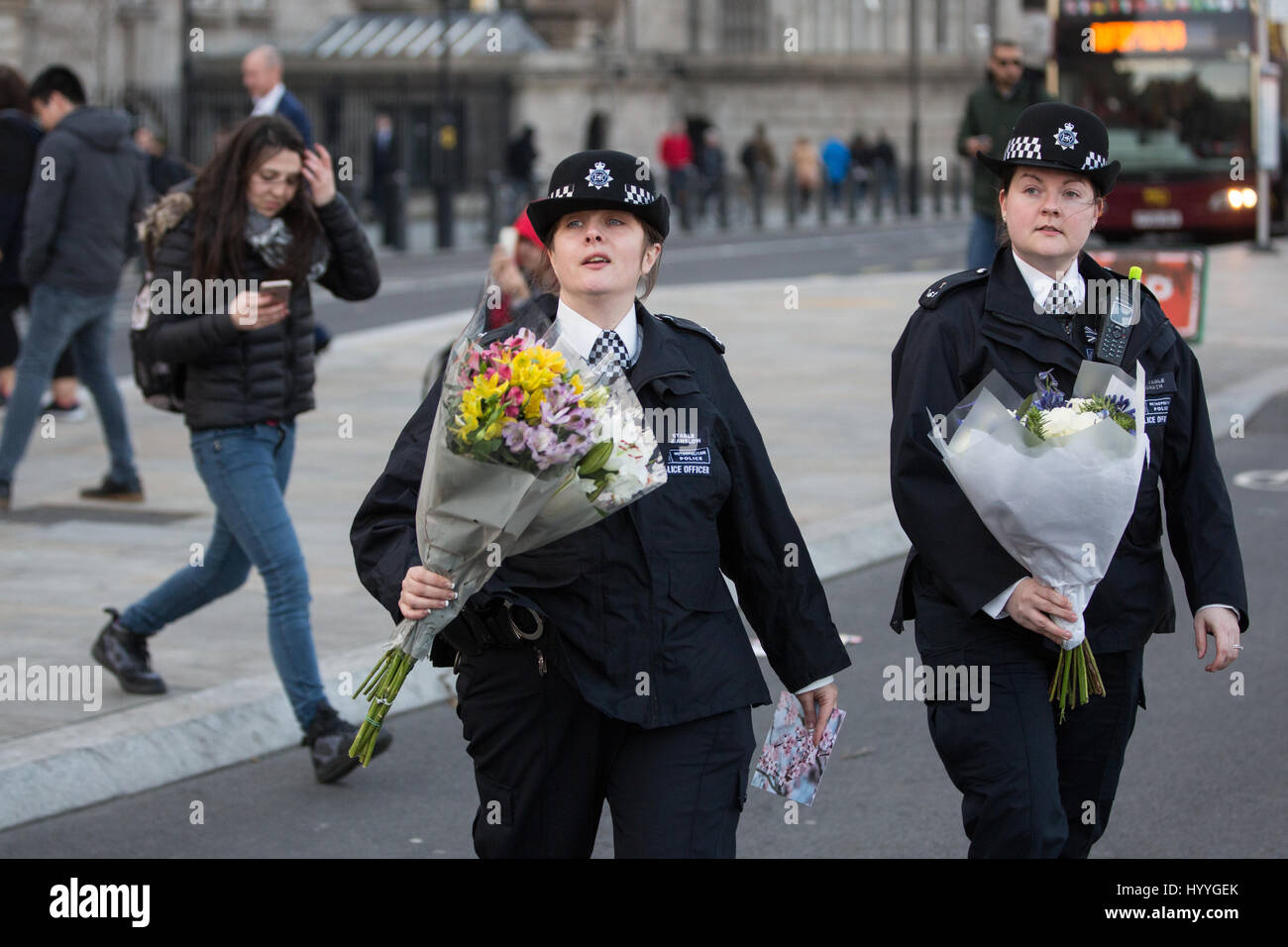 London, UK. 23rd March, 2017. Police officers prepare to lay floral ...
