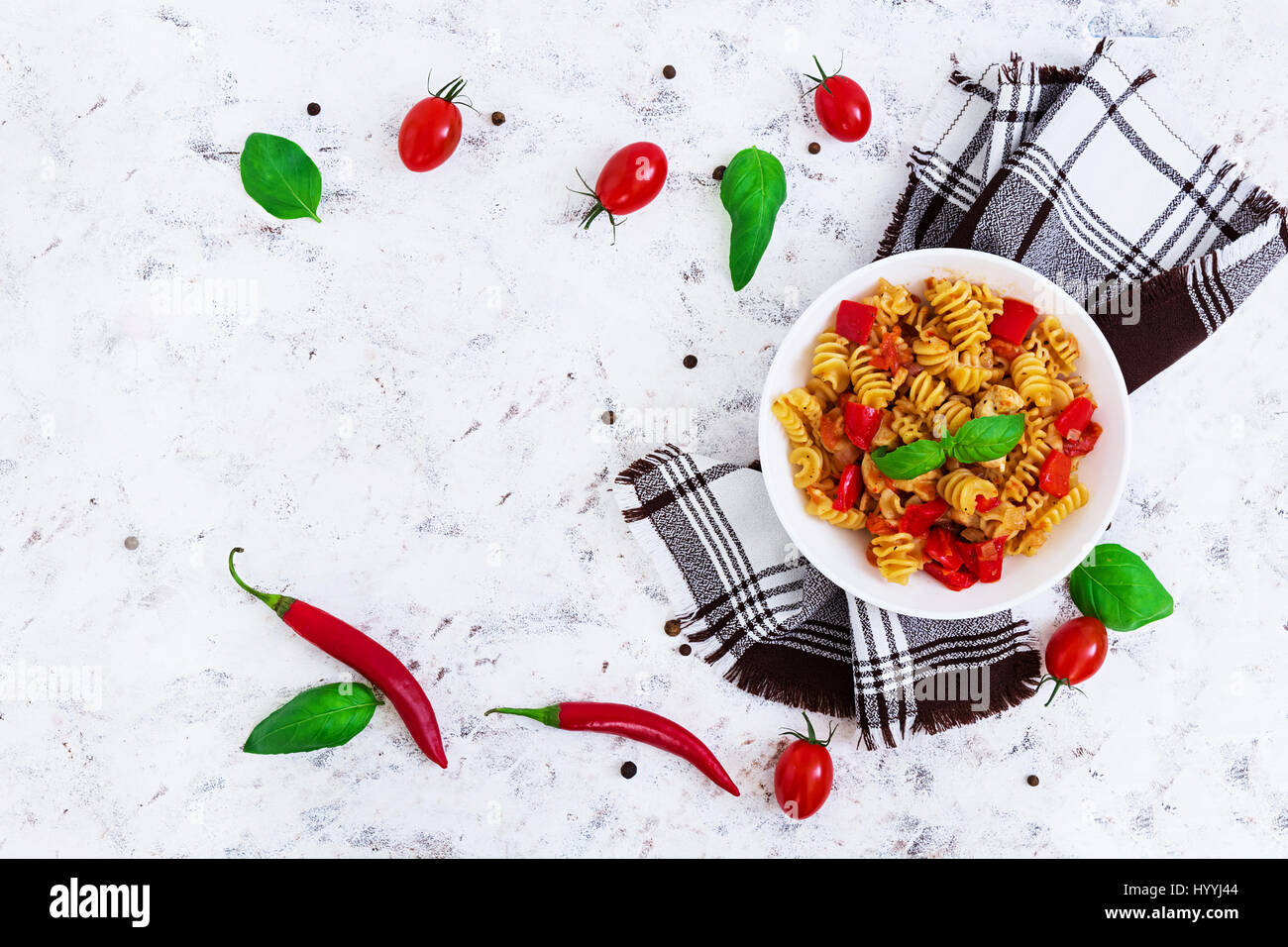Radiatori pasta with chicken and peppers on white background. Top view ...