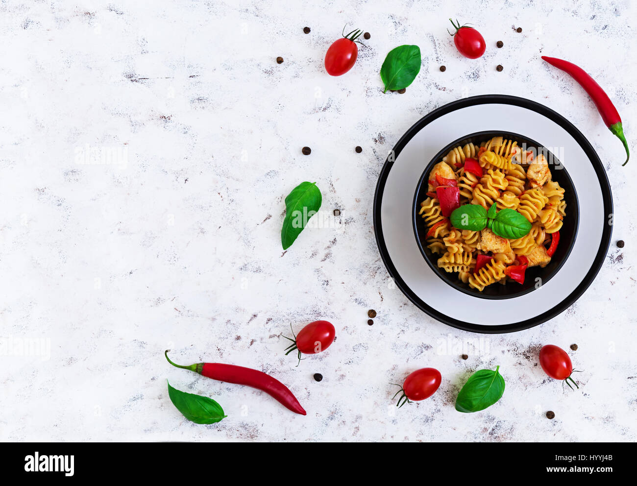 Radiatori pasta with chicken and peppers on white background. Top view ...