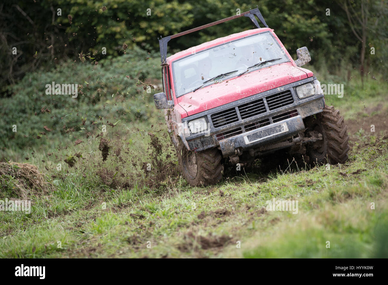 Off road 4x4 car on grass spraying mud up and having fun Stock Photo ...