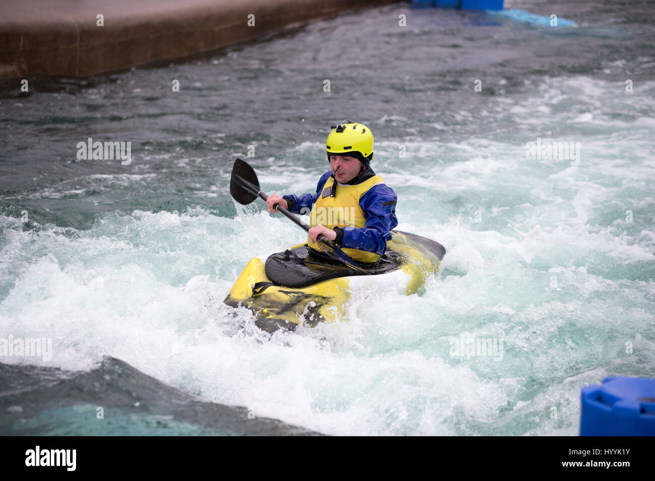 Man in kayak paddling upstream in fast flowing water Stock Photo - Alamy