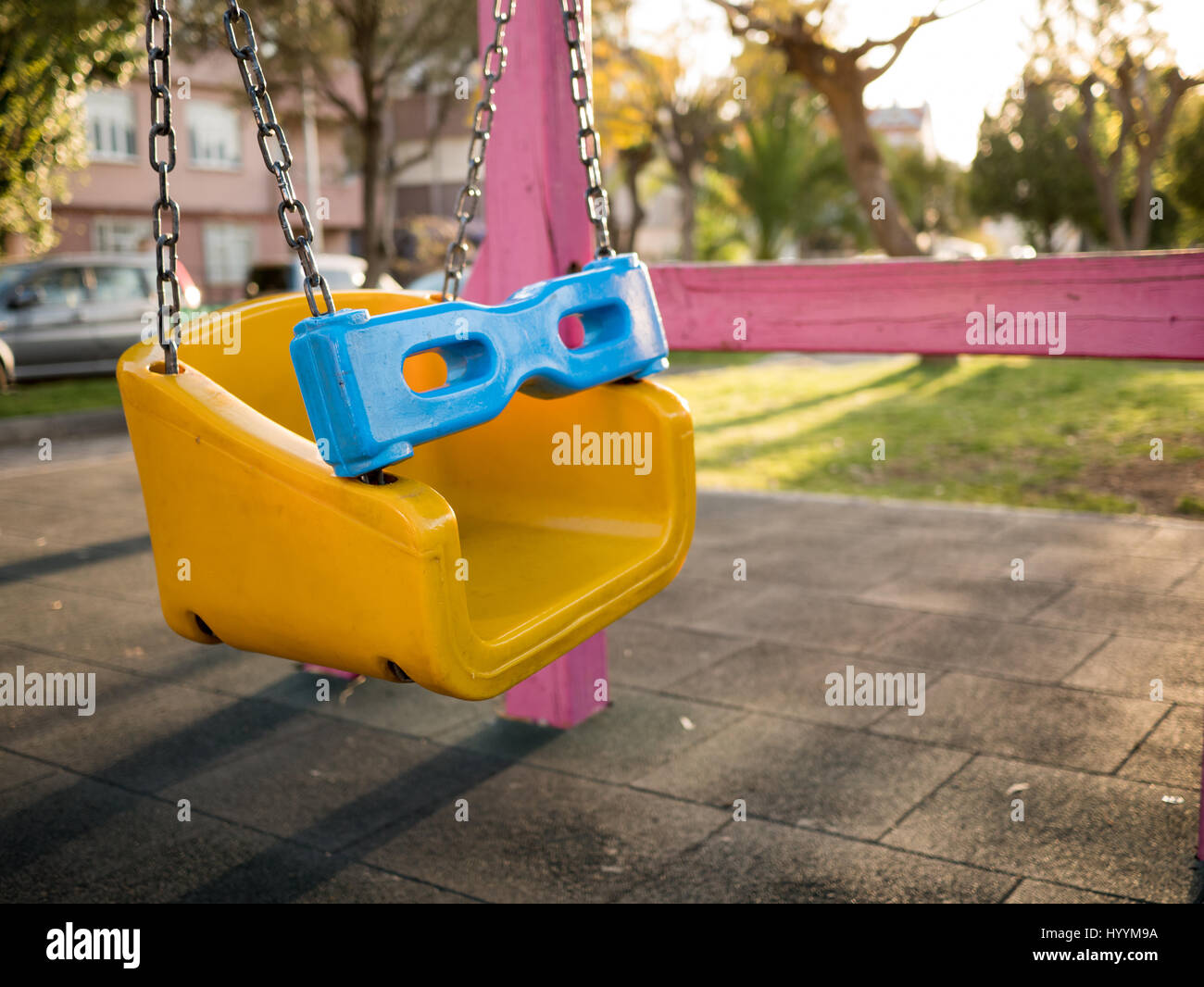 Colorful swing set at a playground in a park Stock Photo - Alamy