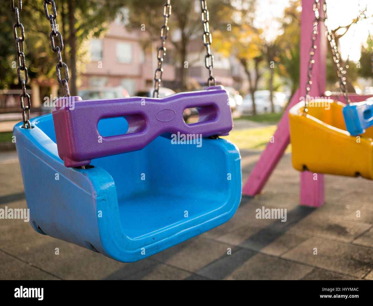 Colorful swing set at a playground in a park Stock Photo - Alamy