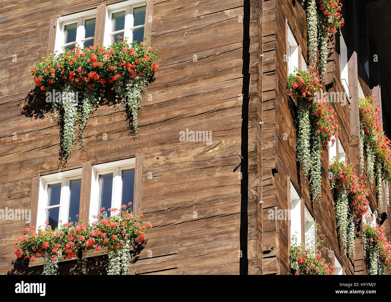 Traditional Swiss chalet and flowers on balconies at Zermatt resort ...