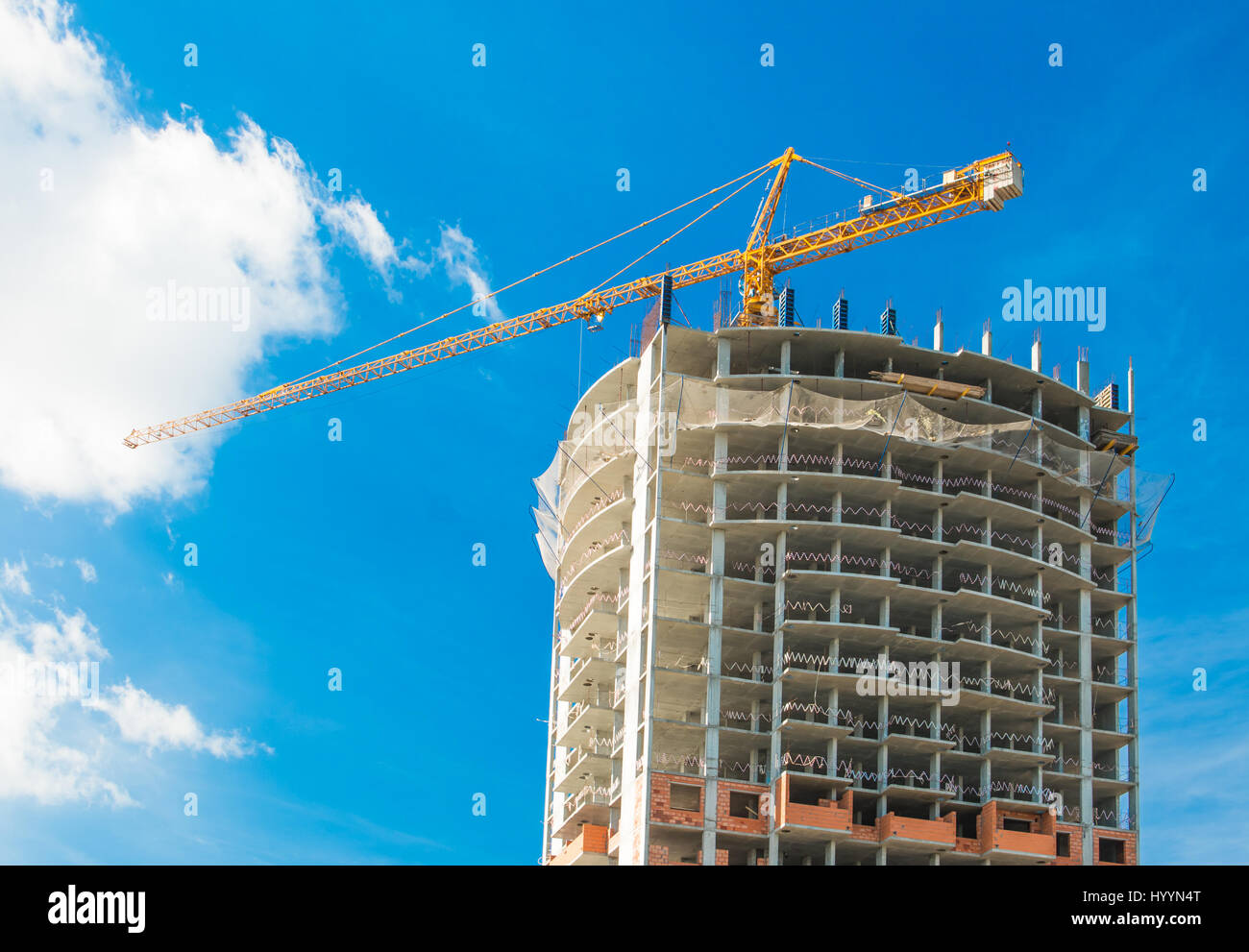 Crane and high-rise building under construction works Stock Photo - Alamy