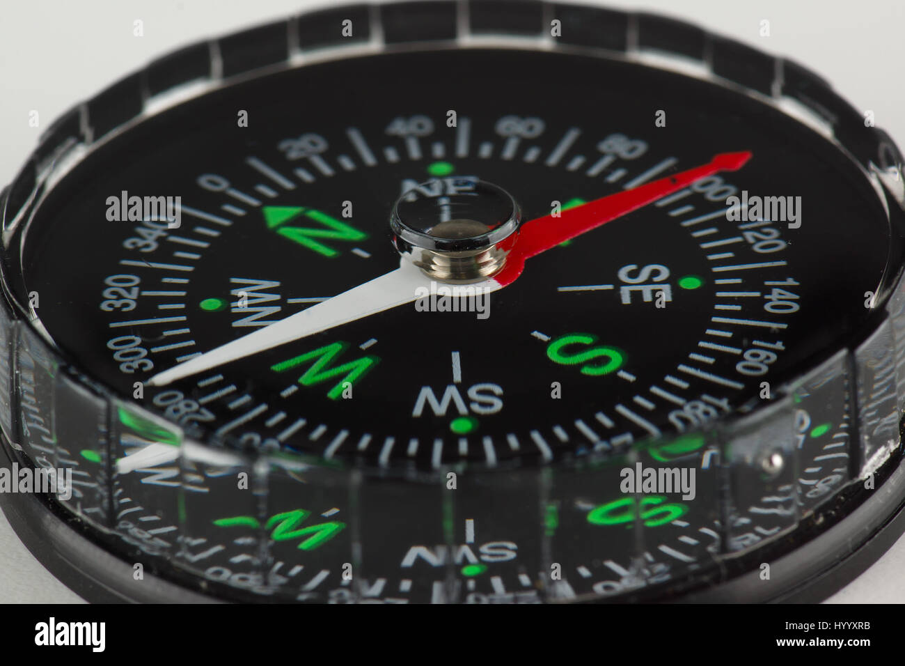 round magnetic compass with bright symbols lies on the table Stock ...
