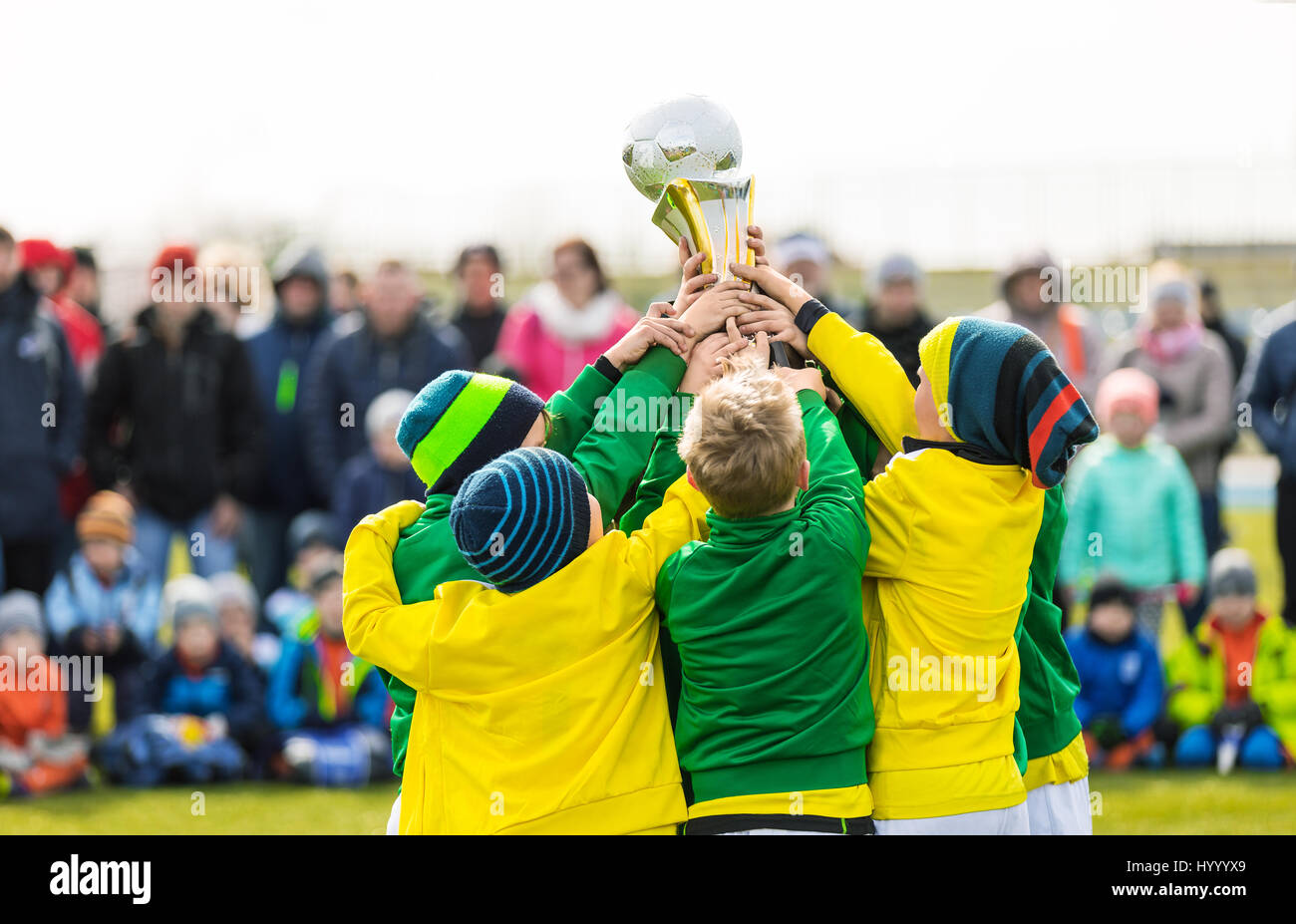Young Soccer Players Holding Trophy. Boys Celebrating Soccer Football Championship. Winning ...