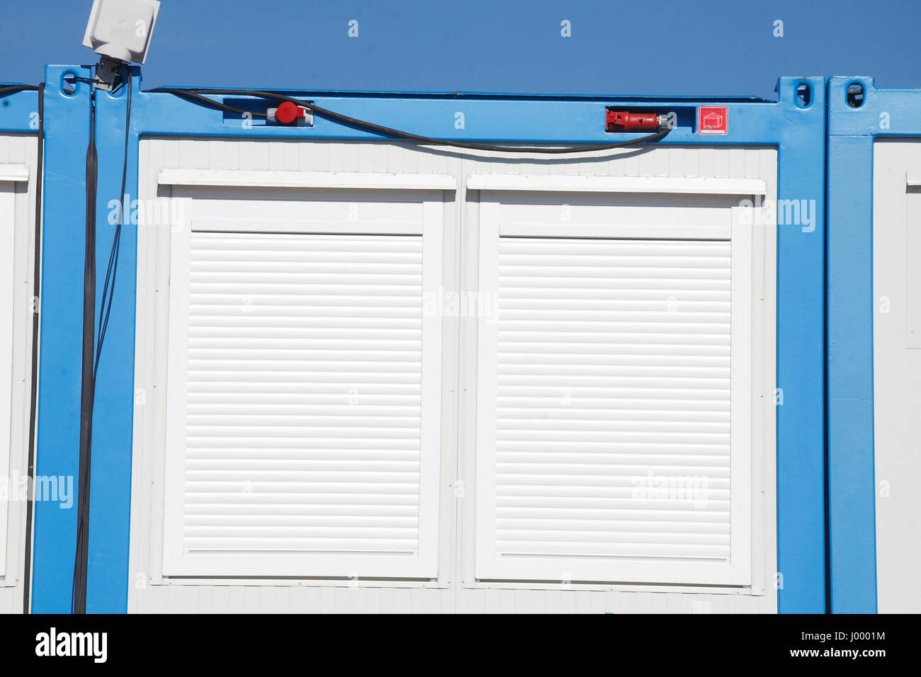 window with a closed shutter on a blue container Stock Photo - Alamy