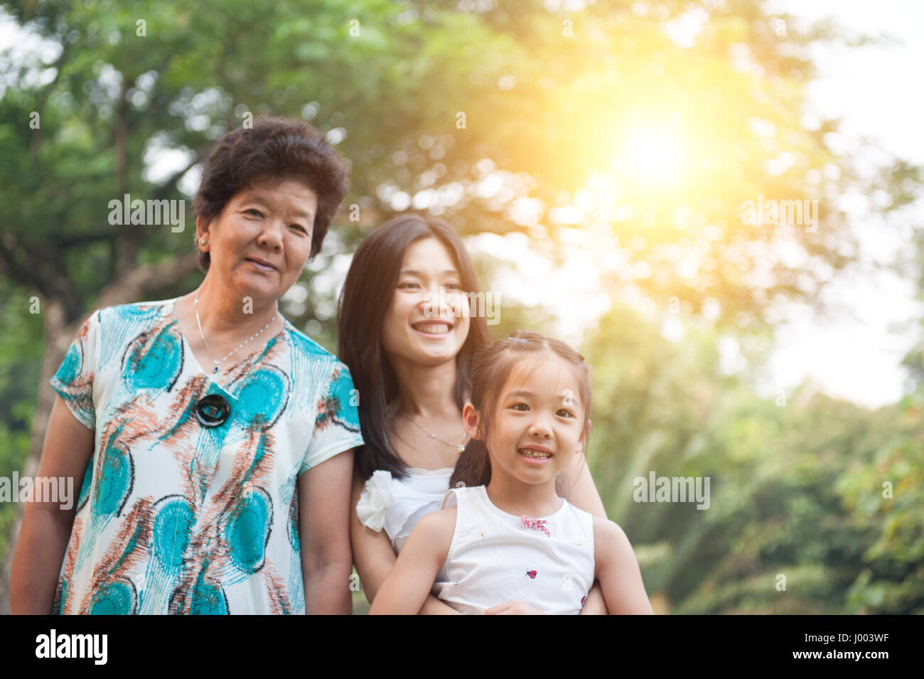 Portrait of happy multi generations Asian family at nature park ...
