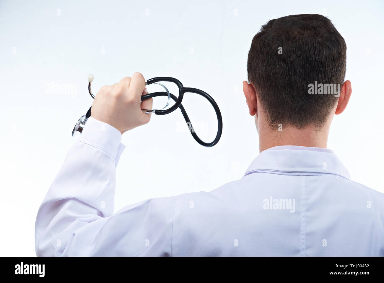 Stethoscope in doctor hand closeup isolated on white background rear ...