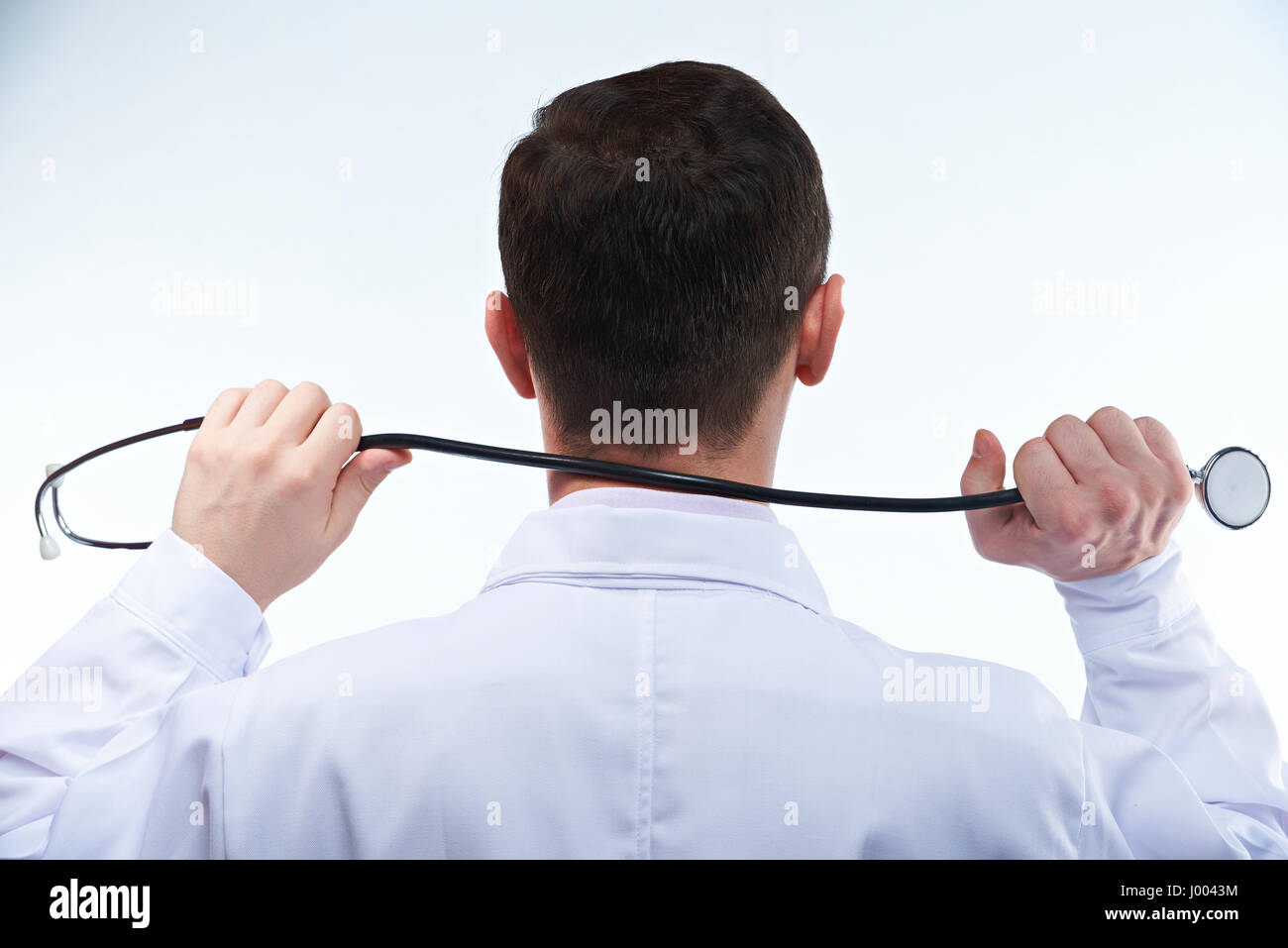 Man doctor with stethoscope rear view closeup isolated on white ...