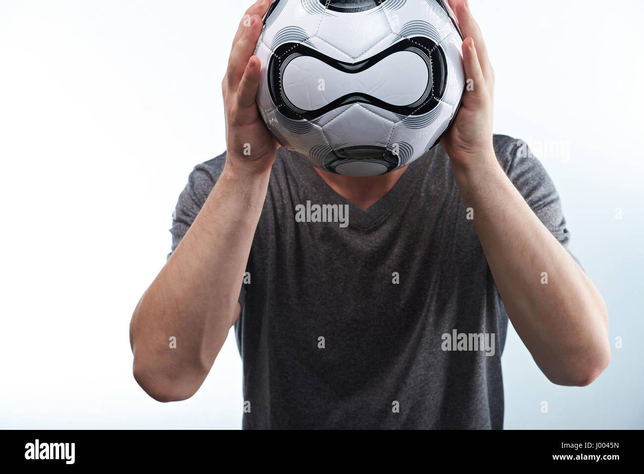 Man hold football ball in front face closeup isolated on white ...