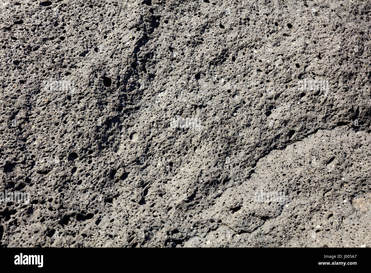 Dark grey volcanic stone as background Stock Photo - Alamy