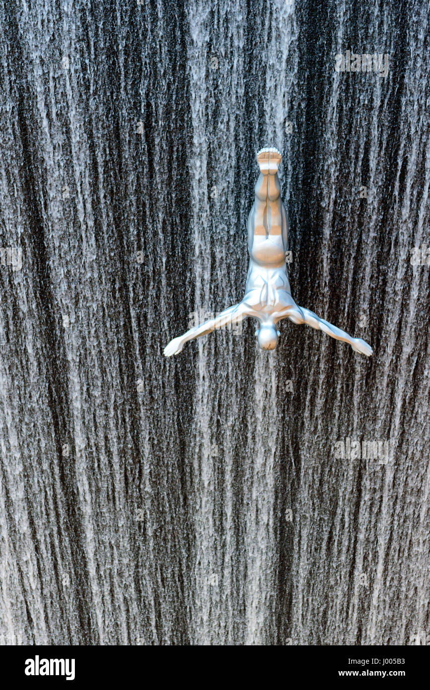 silver male sculpture installed to create a jumping effect on the ...