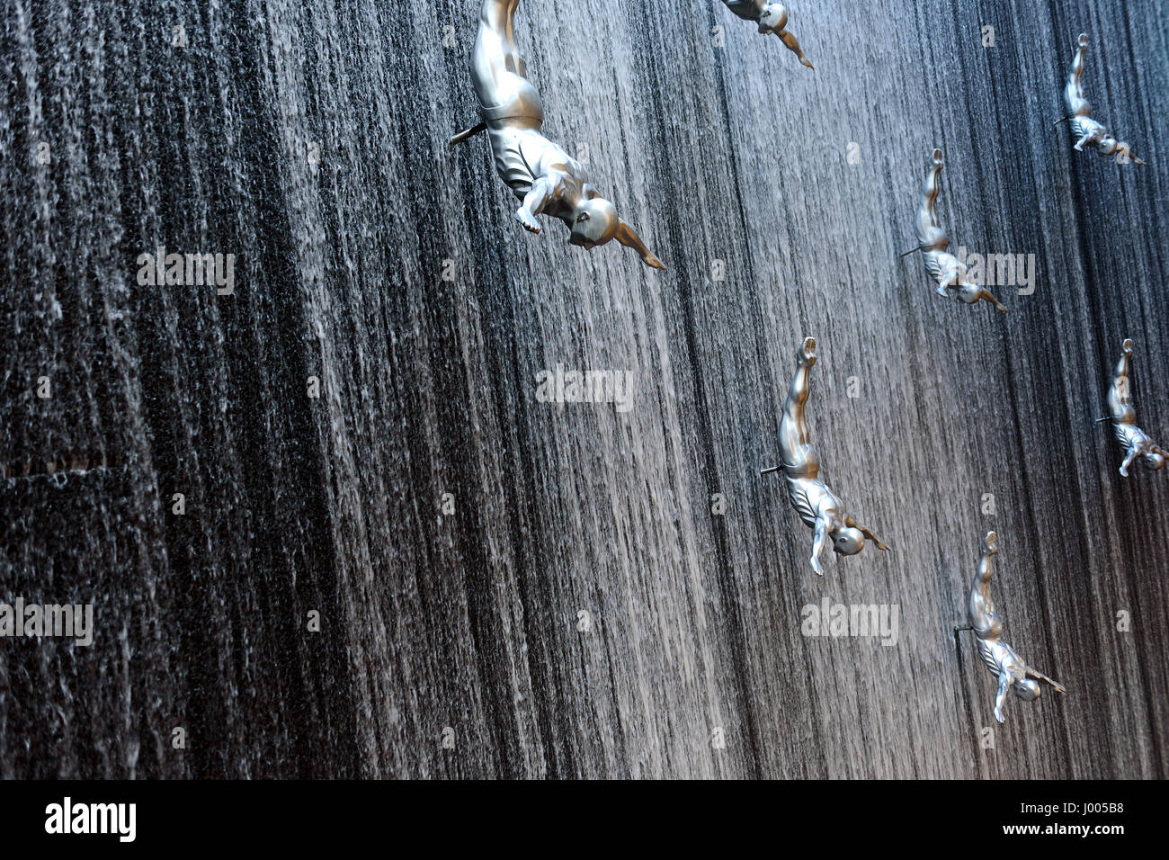 silver male sculpture installed to create a jumping effect on the ...
