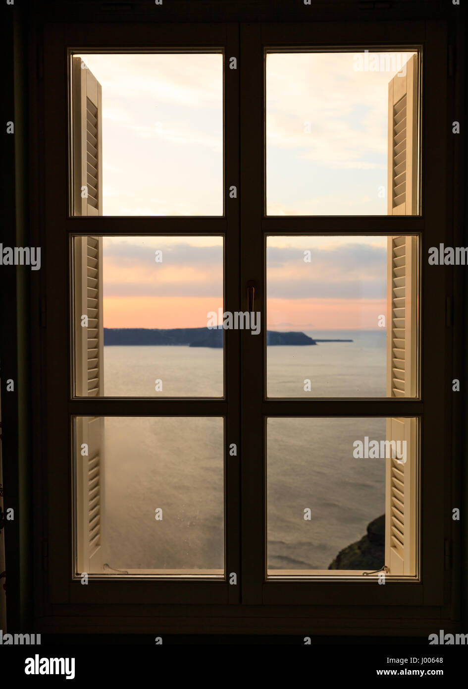 Beautiful sunset at Santorini island Greece - window view Stock Photo ...