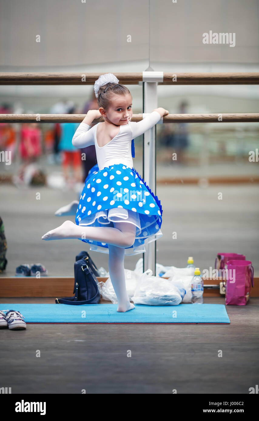 Little ballerina practicing in a dance class. Child girl posing at ...