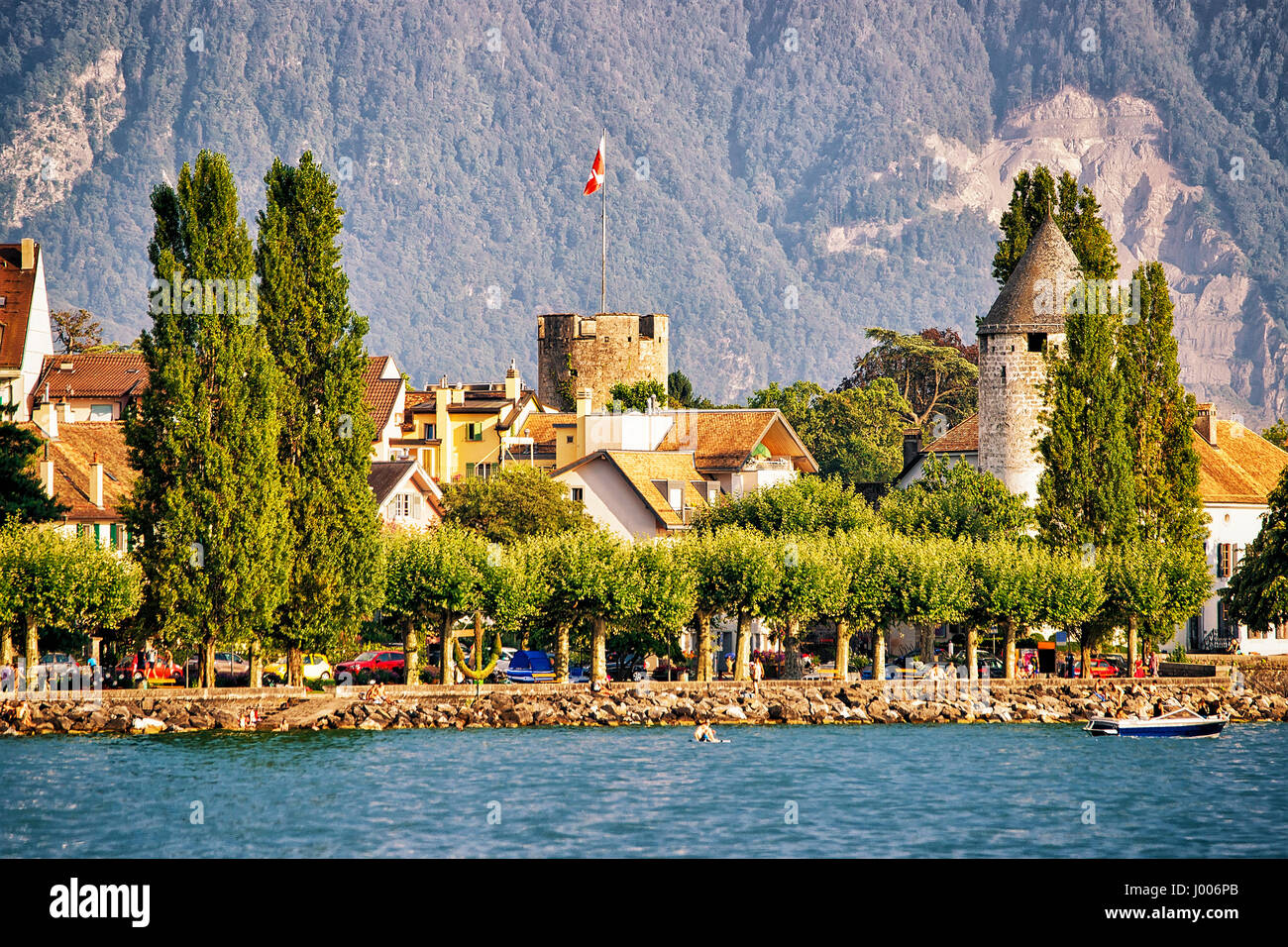 Town with towers and Alps mountains, and Geneva Lake Riviera in Vevey ...