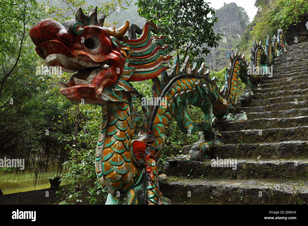 Carved stone dragon. Ascending staircase to Hang Mua pagoda and Mua ...