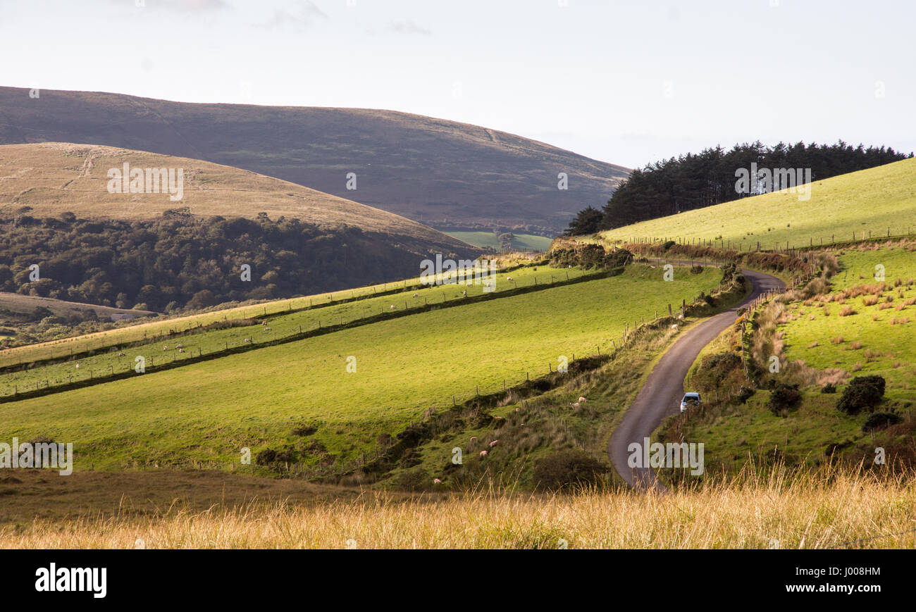 A narrow mountain pass leads down the slopes of Caherconree mountain ...