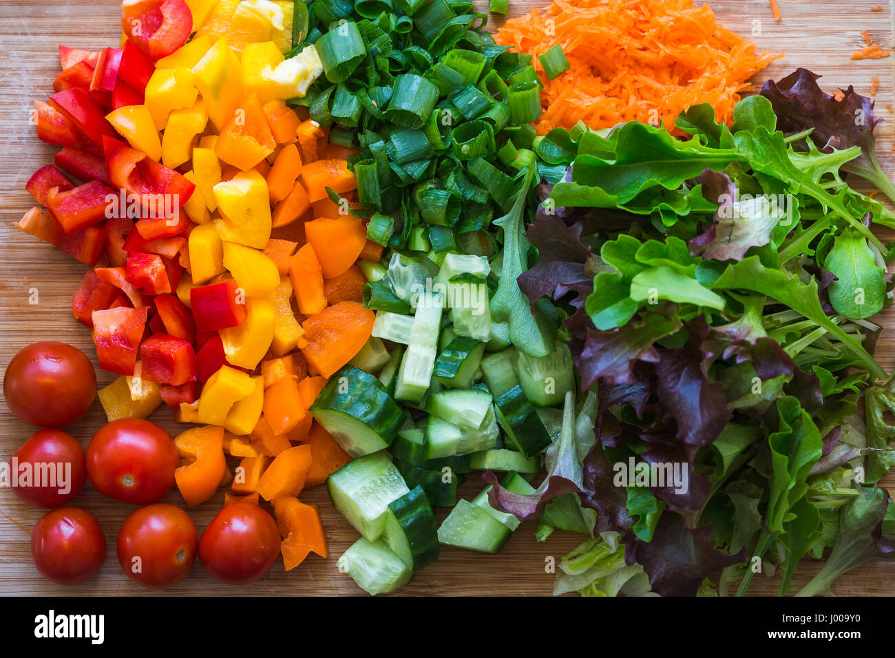 An English style salad chopped up on a board at spring time. The salad ...