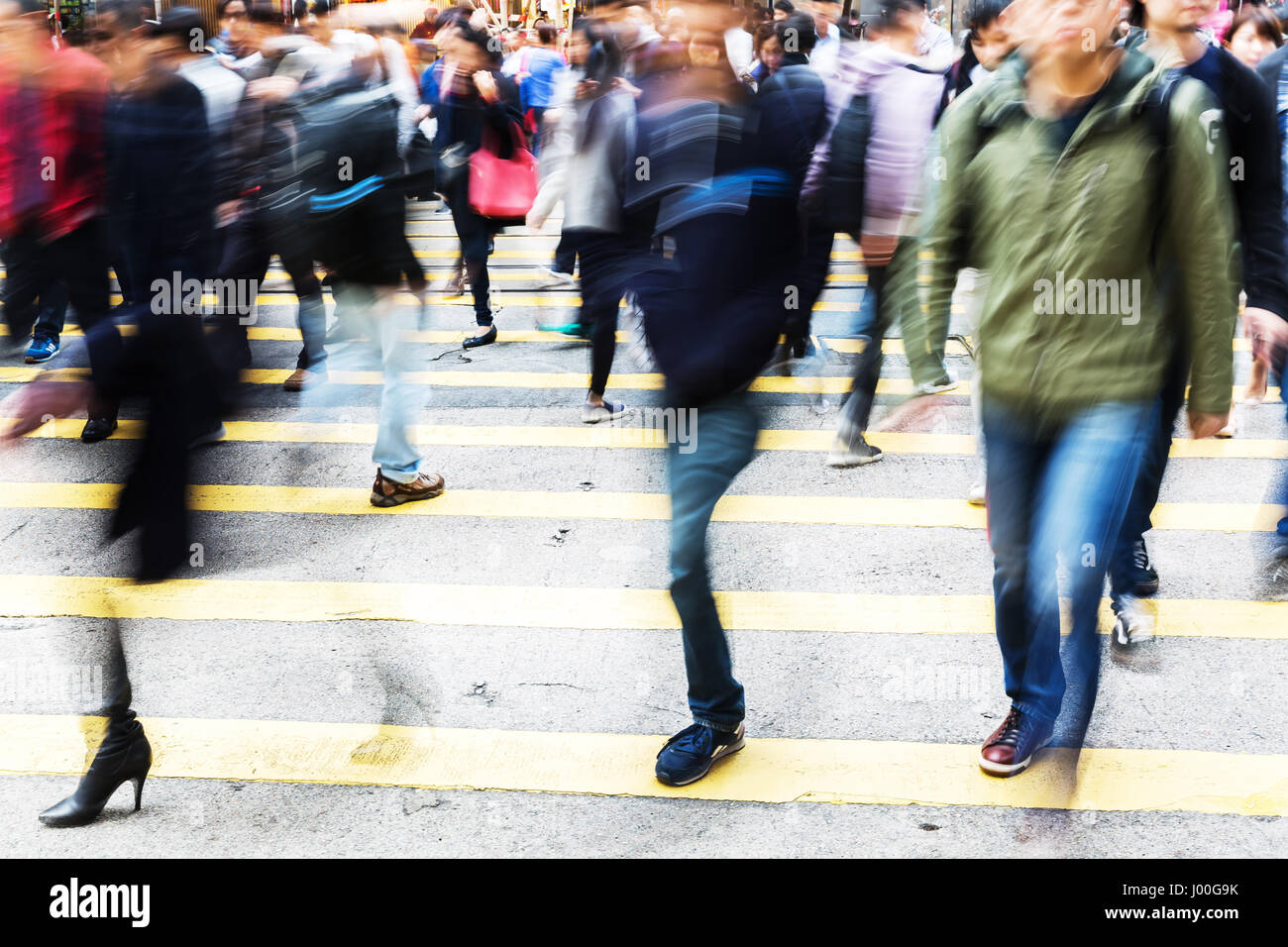 crowd of people crossing a city street in motion blur Stock Photo - Alamy